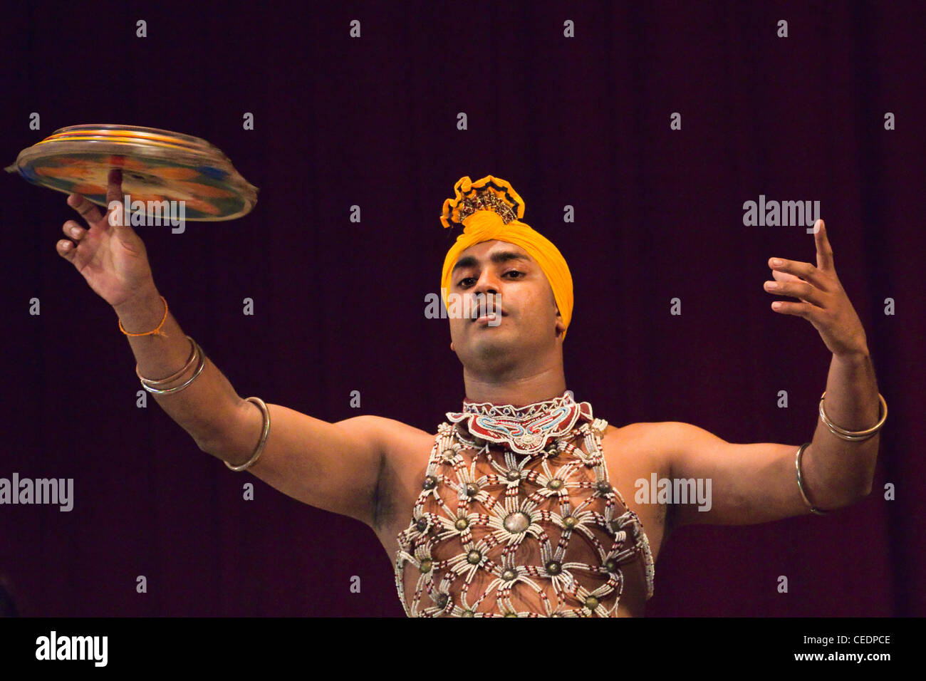Man performing the Raban Dance & balancing a drum in a tourist show at ...