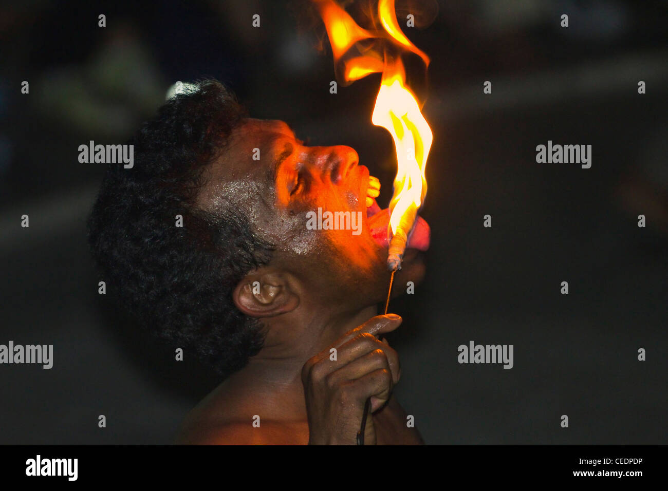 Man 'eating' fire during the Fire Walking at a Kandyan dance show in ...