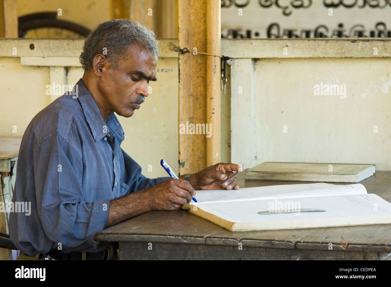 Man writing in ledger hi-res stock photography and images - Alamy