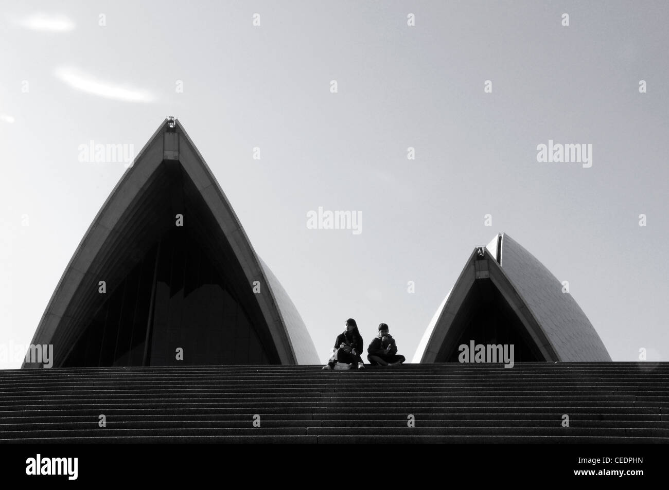 Two people seated on the steps of the Sydney Opera House Stock Photo ...