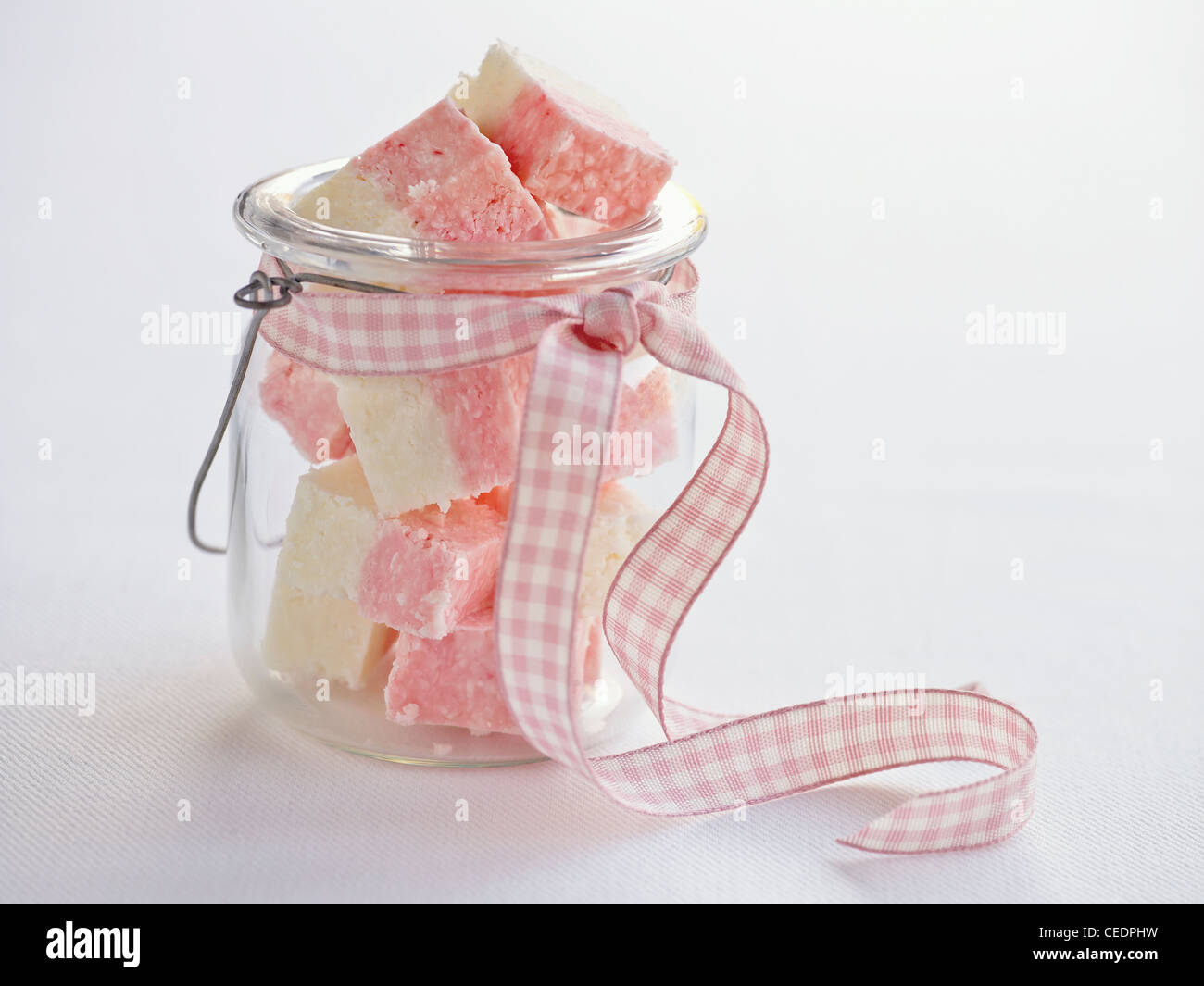 Coconut ice sweets in jar Stock Photo - Alamy