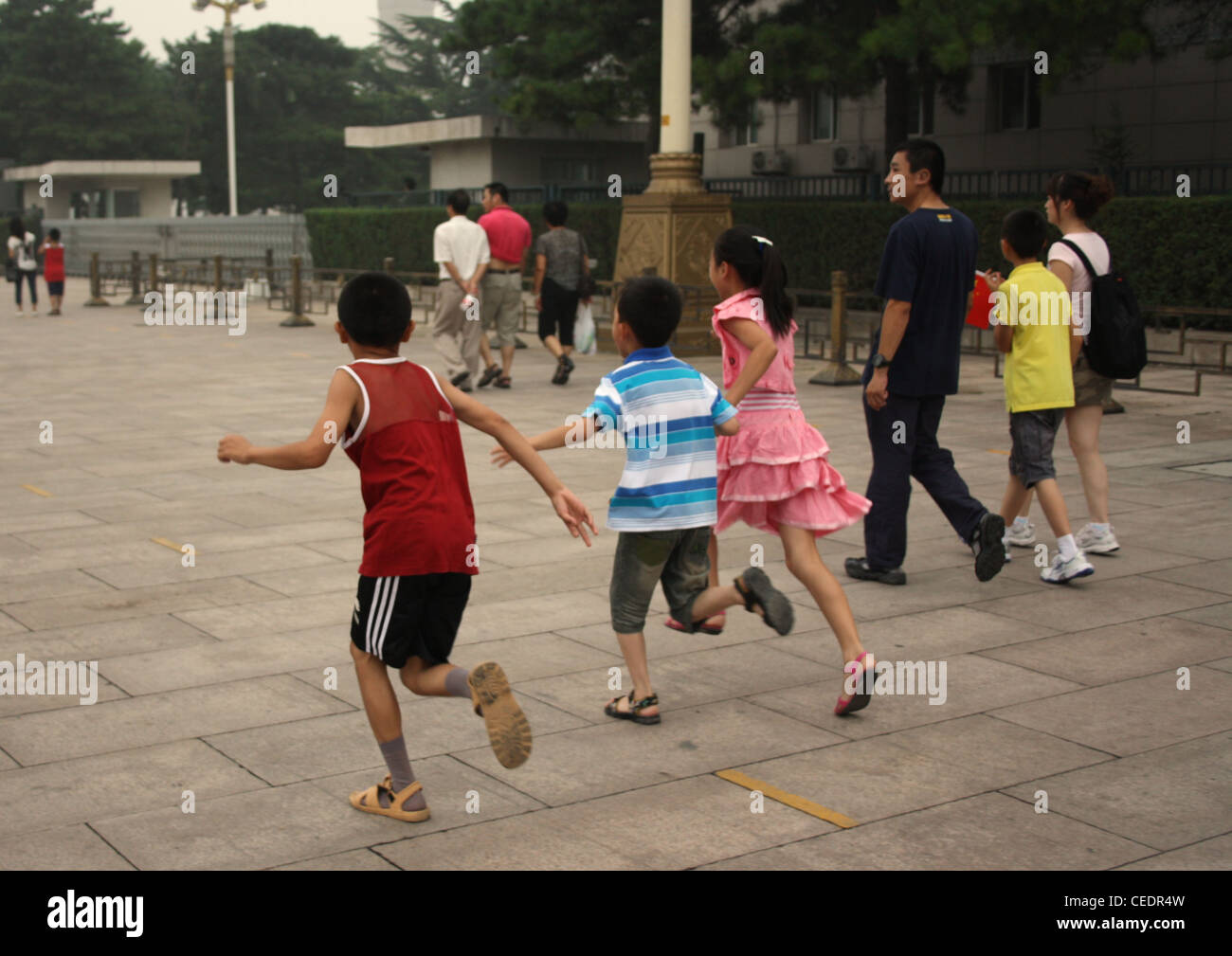 Children running after kites Stock Photo - Alamy