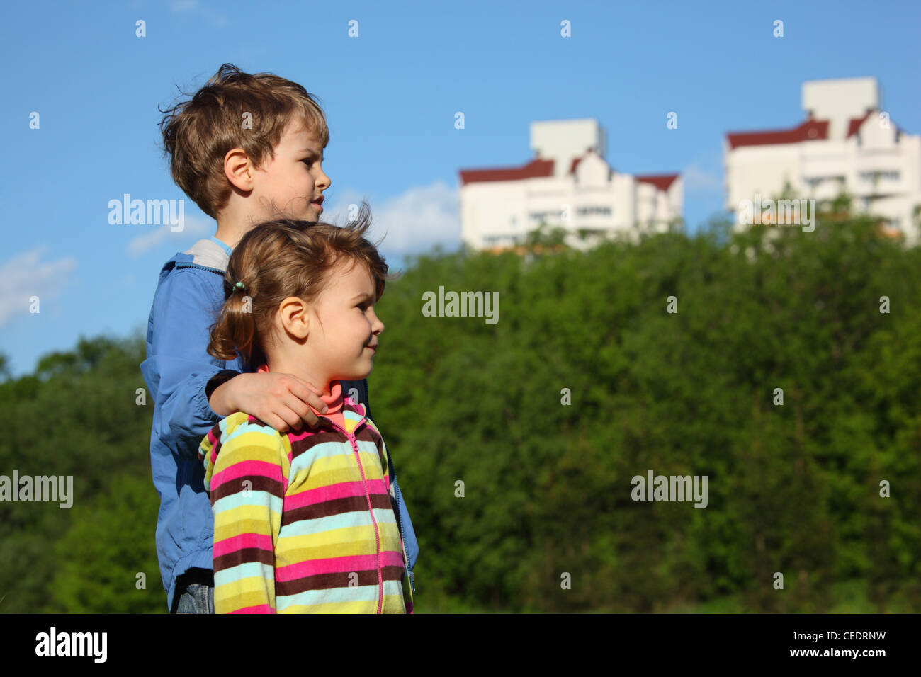 Two children, trees and houses Stock Photo - Alamy