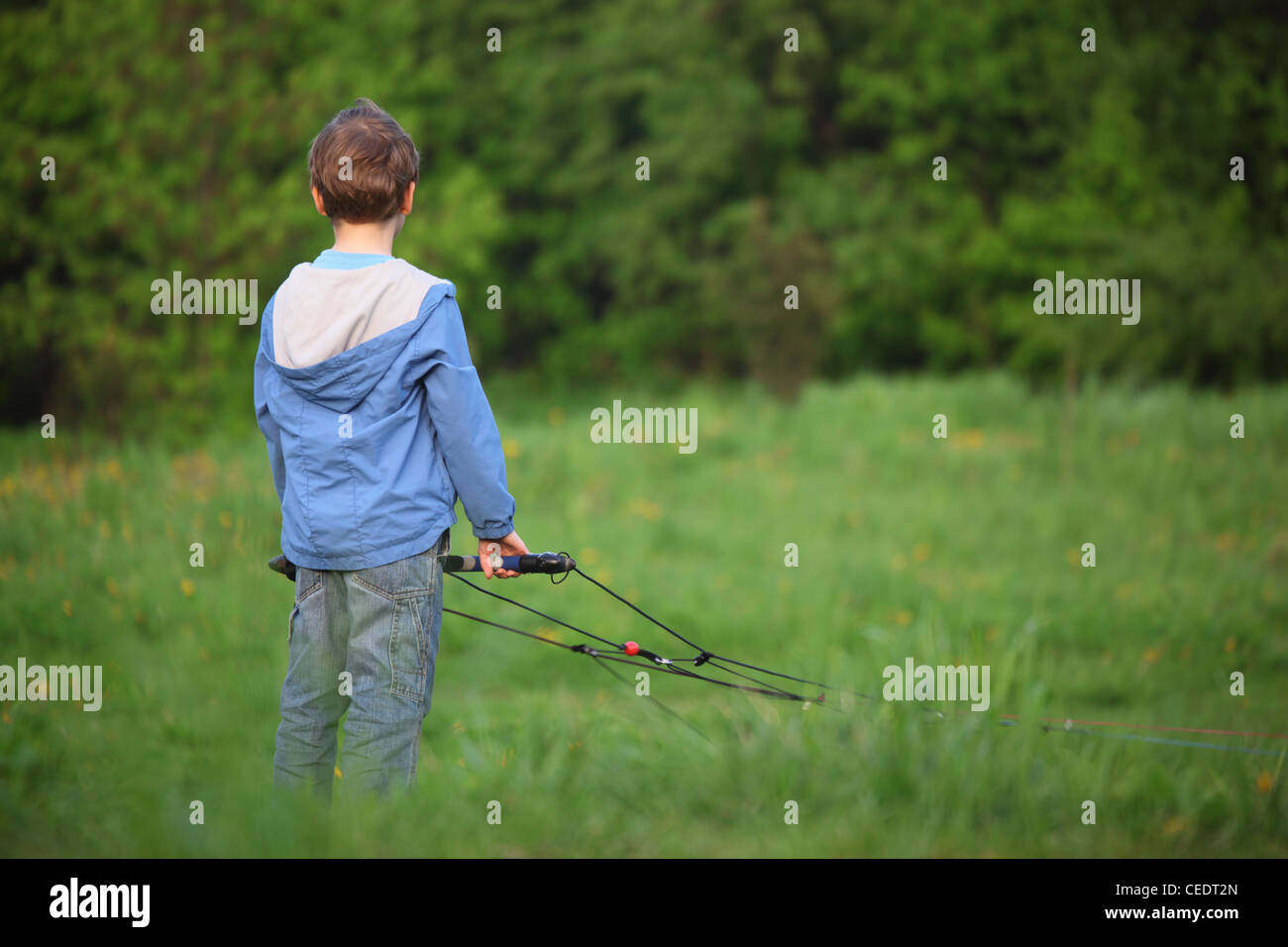 behind boy ready to kite fly on meadow Stock Photo - Alamy