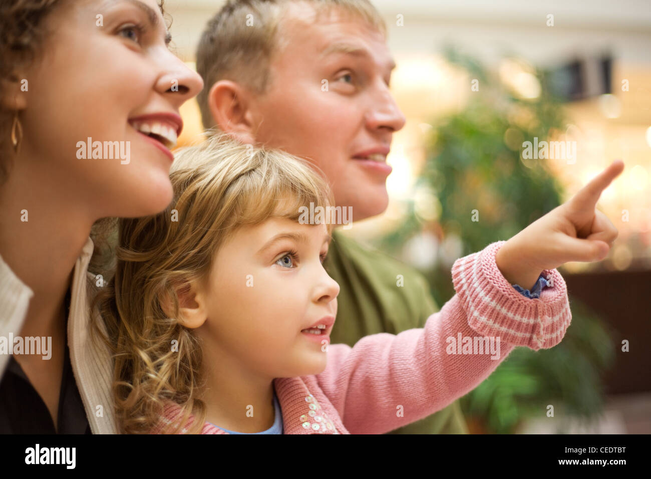 family with little girl with hand pointing finger forward Stock Photo ...