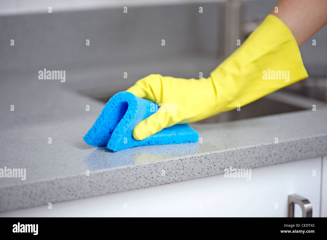 Wiping kitchen surface Stock Photo - Alamy
