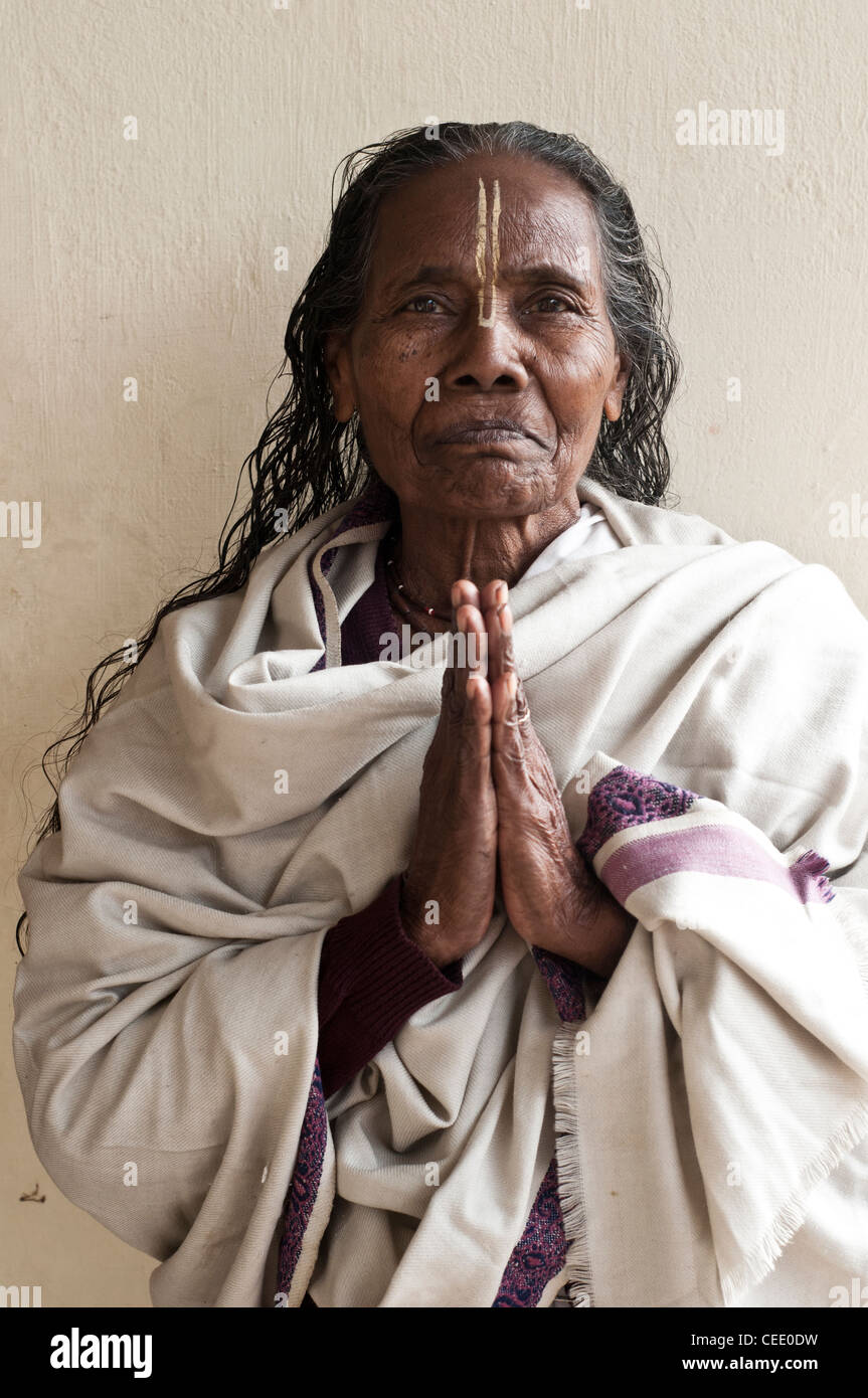 Portrait of a widow with hands clasped in prayer, Chatanya Bihar ashram ...