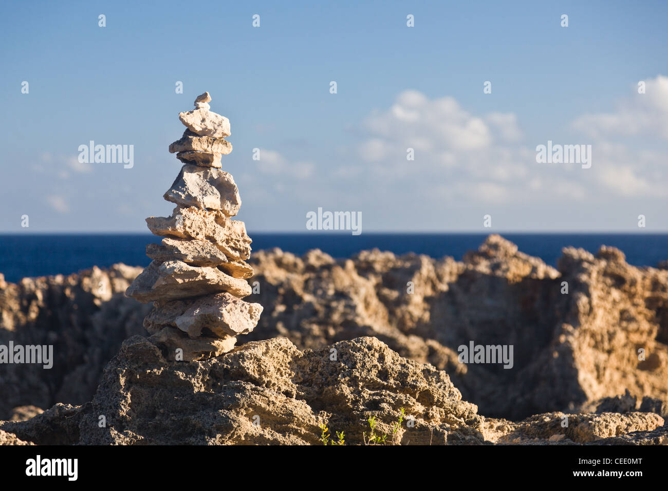 Pyramid shaped stack of rocks balanced on the edge of ocean Stock Photo ...
