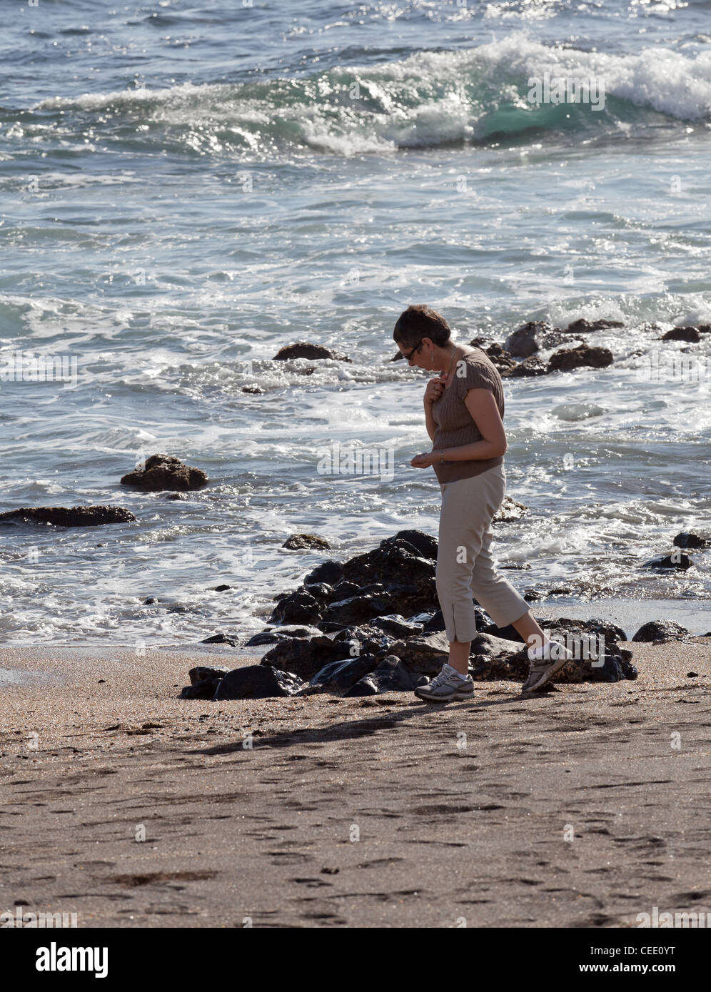 Woman beachcombing on Glass Beach in Kauai Stock Photo - Alamy