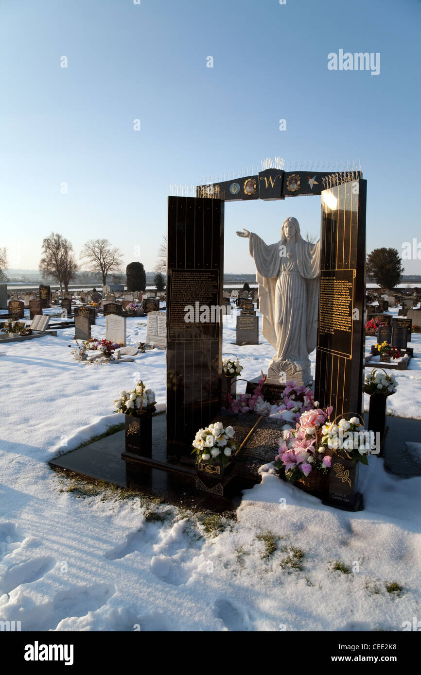A grave and statues in winter, UK Stock Photo - Alamy