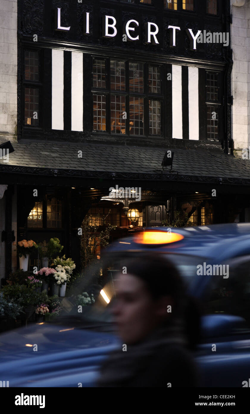 The Liberty store in London with a person and a taxi passing Stock ...