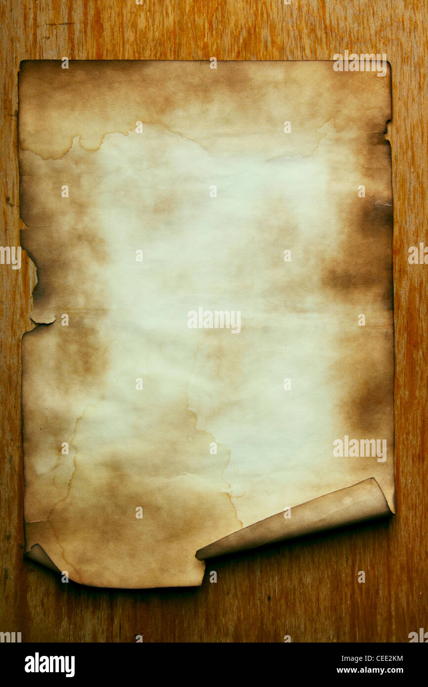 Single old paper on a wood table Stock Photo - Alamy