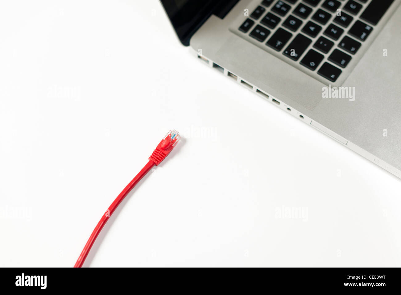 Ethernet patch cable sitting beside Apple Macbook Pro laptop Stock ...