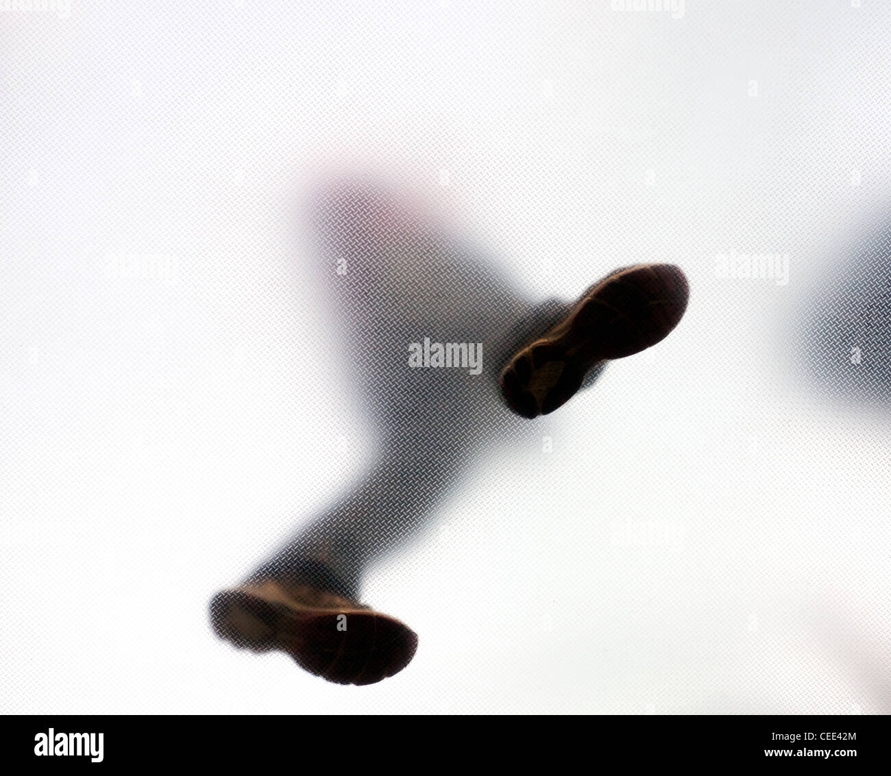 A bottom underside view of people walking across a translucent opaque ...