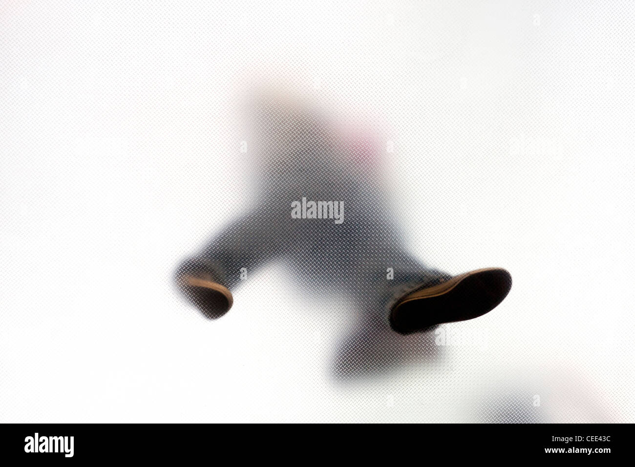 A bottom underside view of people walking across a translucent opaque ...