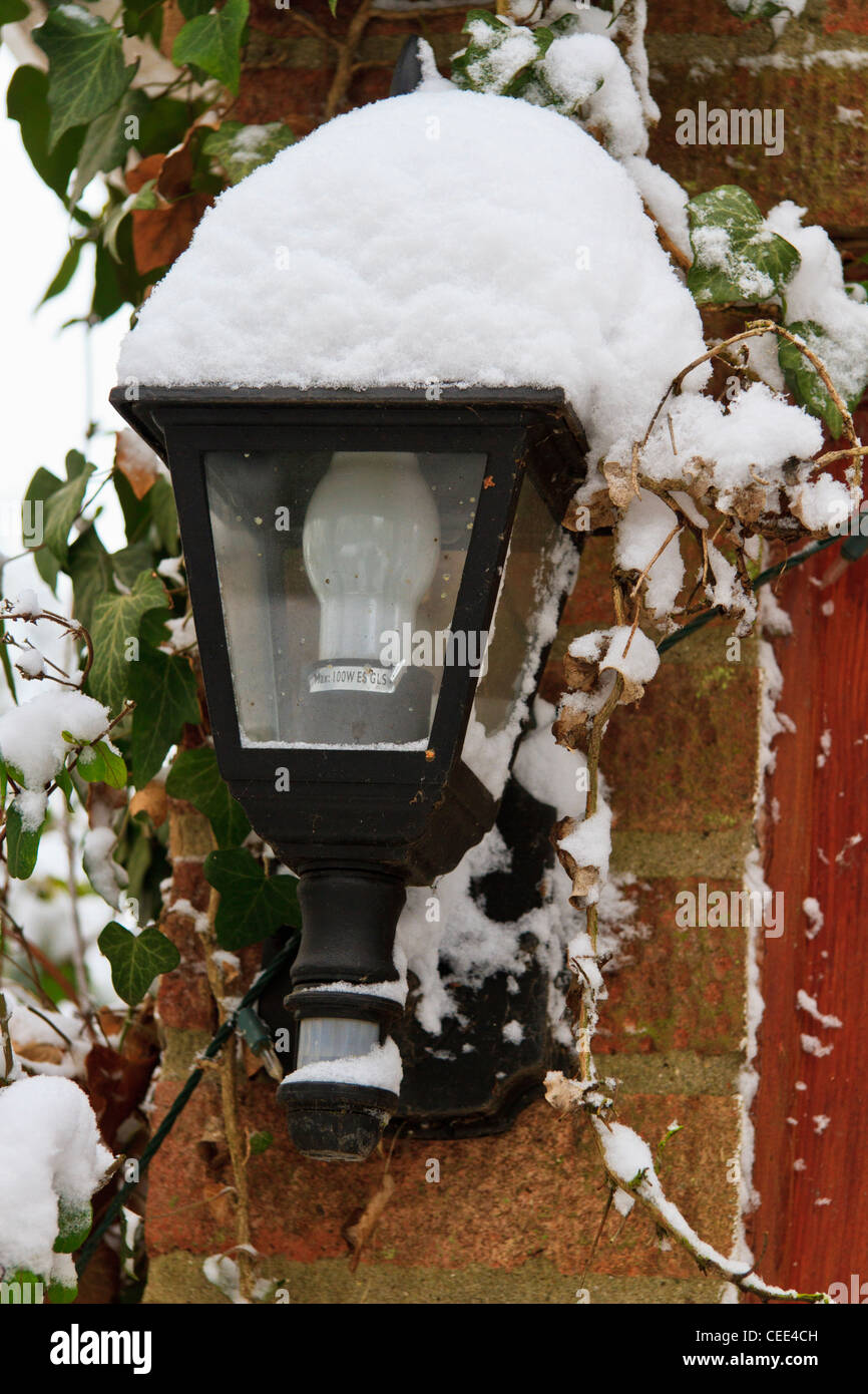 Exterior wall light covered in snow Stock Photo - Alamy