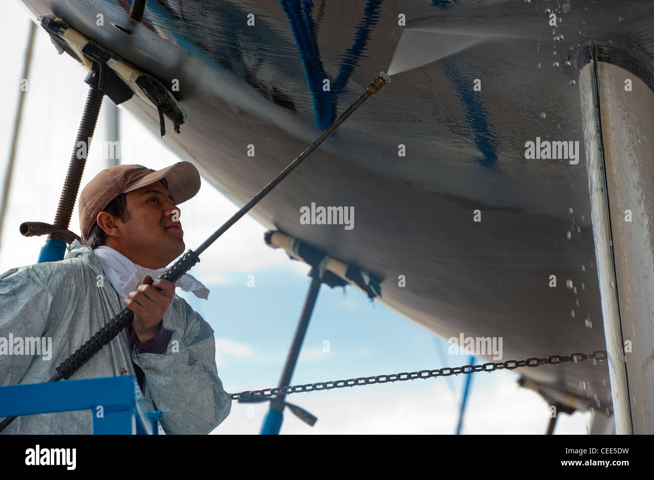 Pressure washing a sailboat Stock Photo - Alamy