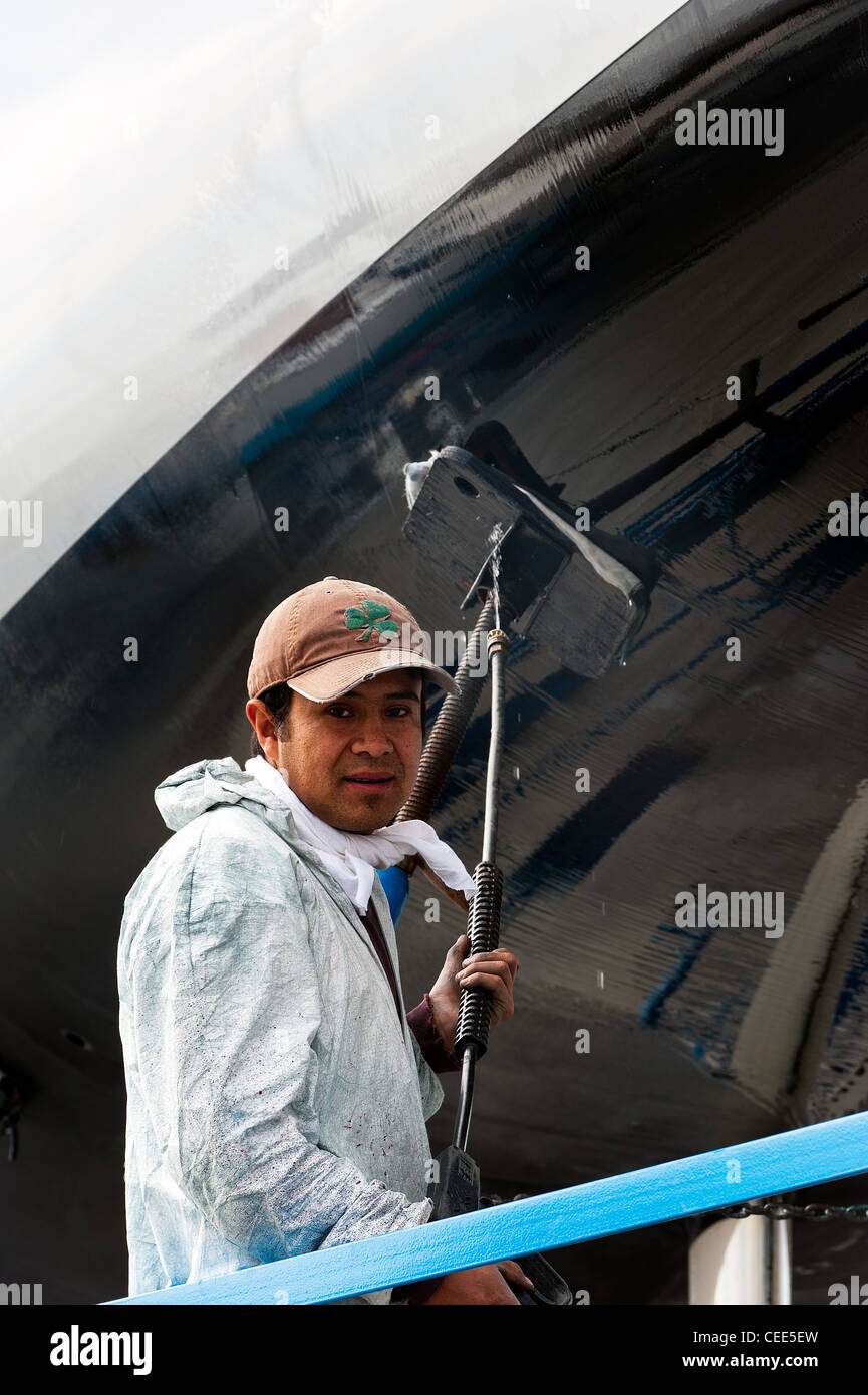 Pressure washing a sailboat Stock Photo - Alamy