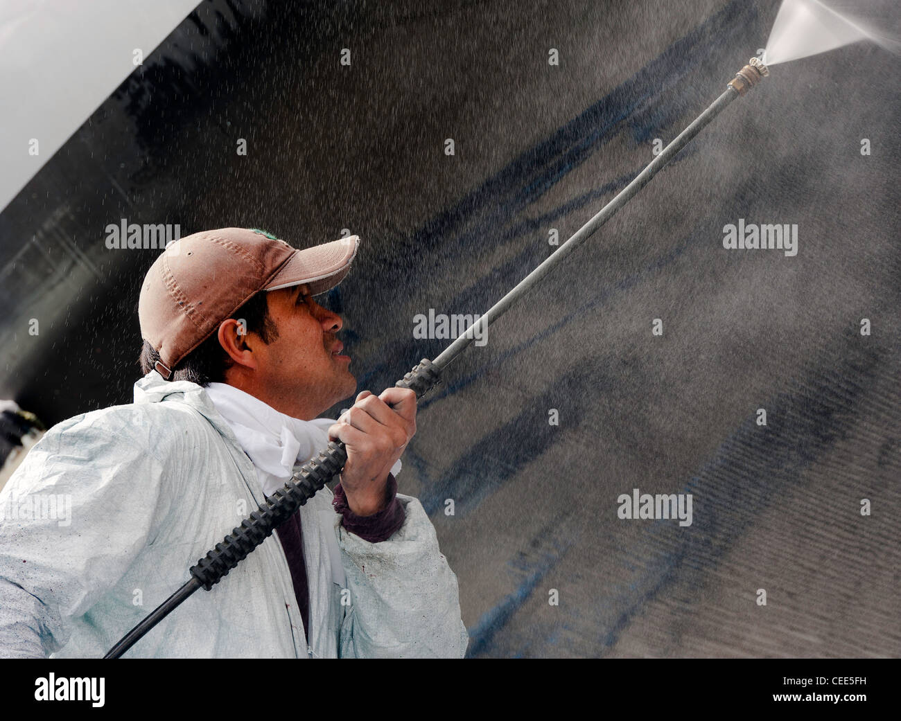 Pressure washing a sailboat Stock Photo - Alamy