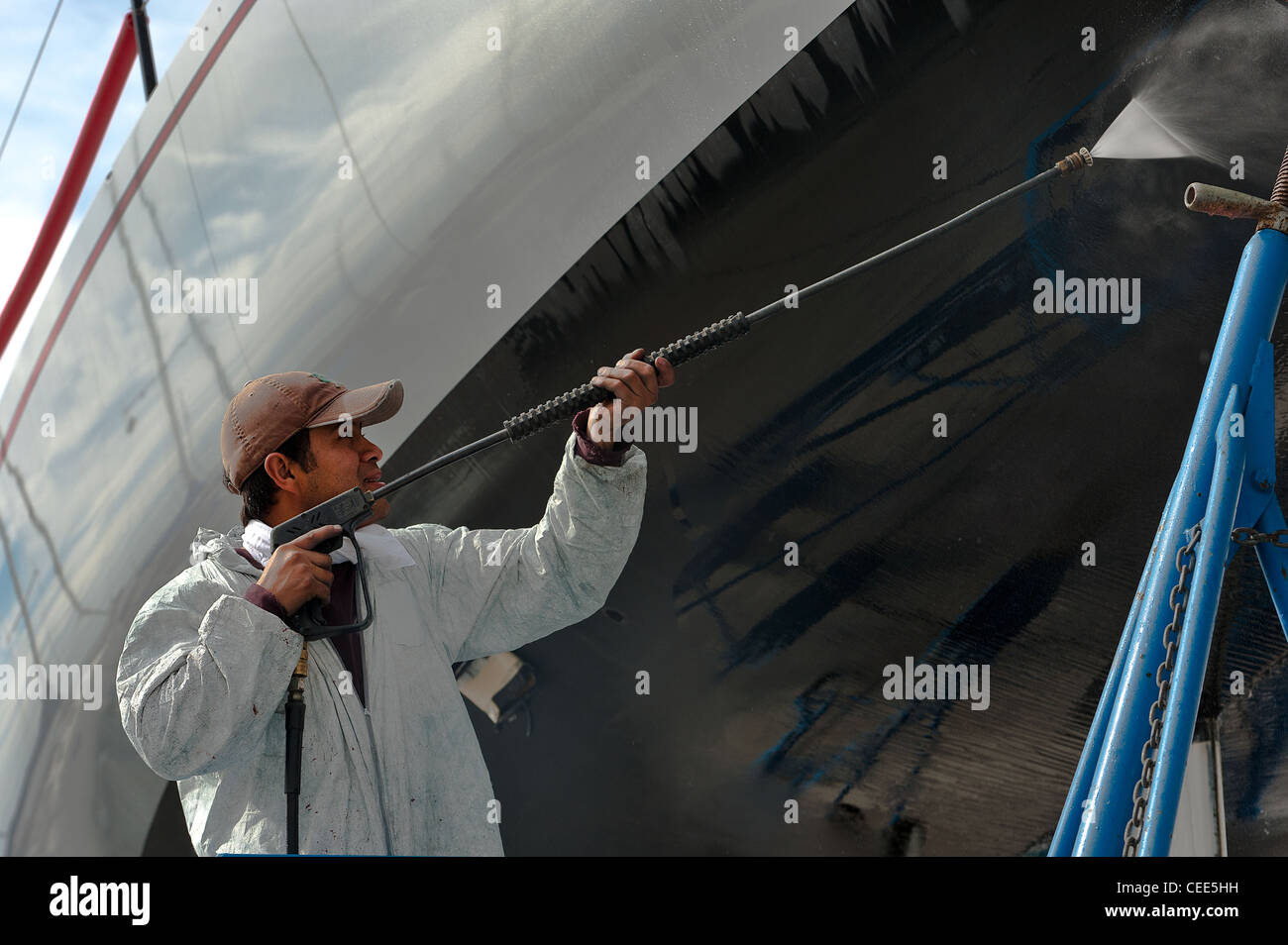 Pressure washing a sailboat Stock Photo - Alamy