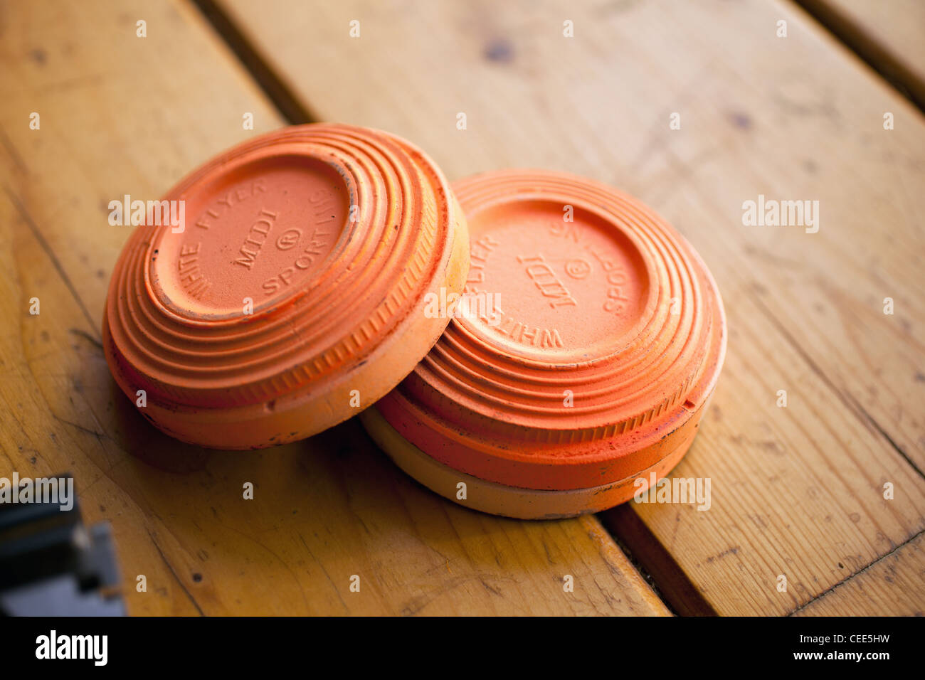 A pair of orange clay shooting targets Stock Photo - Alamy