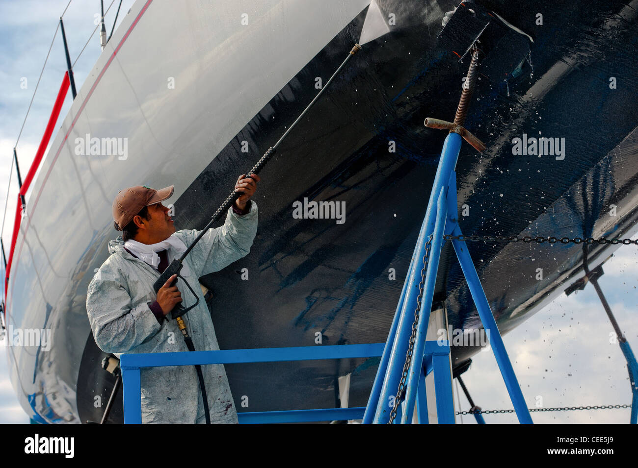 Pressure washing a sailboat Stock Photo - Alamy