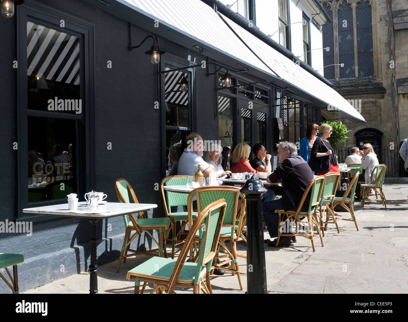 People sitting outside of a UK cafe Stock Photo - Alamy