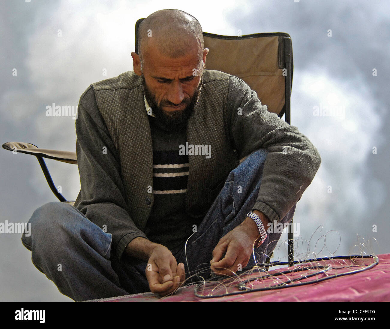 An Afghan falconer prepares a handmade snare trap for birds nesting ...