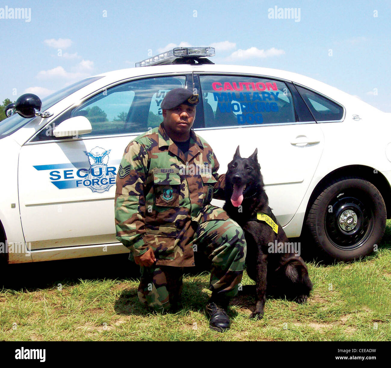 Staff Sgt. Marcus Reaves sits with his military working dog, Arras, at ...