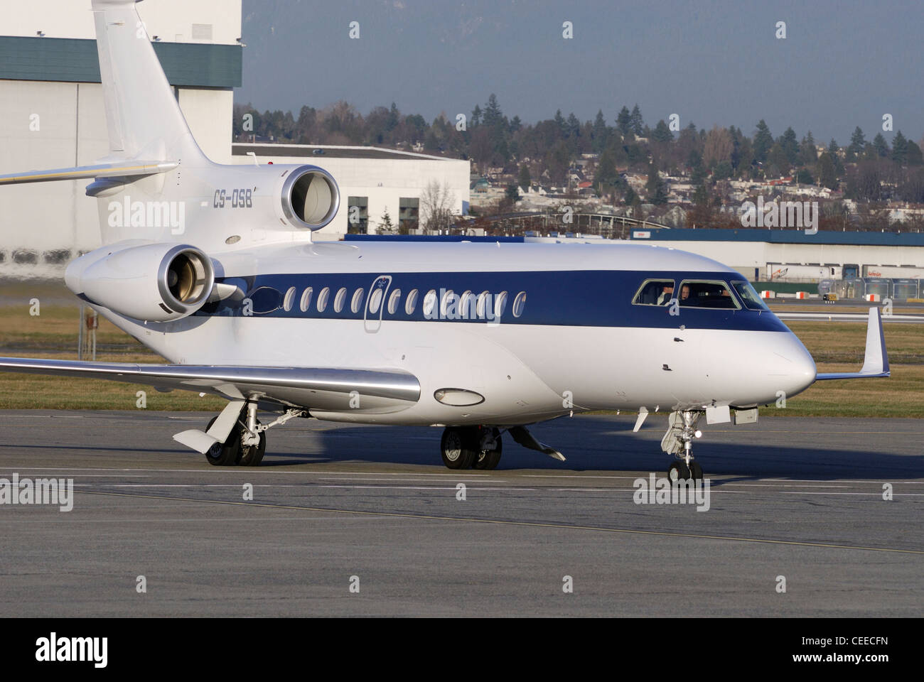 Dassault Falcon 7X triple jet engines on the tail taxiing down runway ...