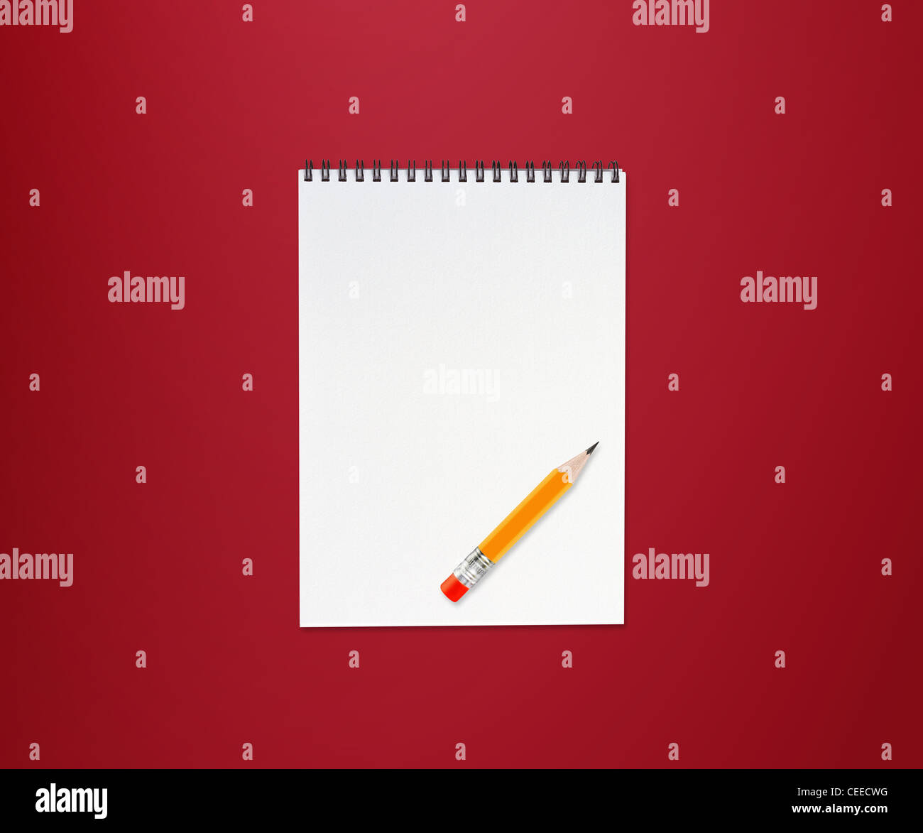 Notebook and small yellow pencil with eraser on red background Stock ...