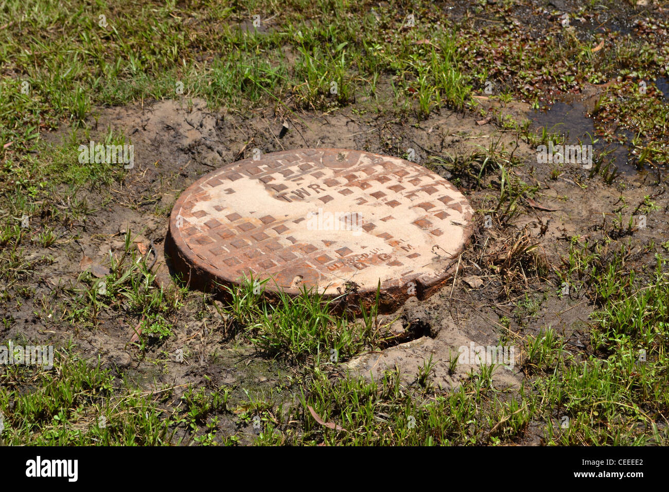 Drain cover after rain Stock Photo - Alamy