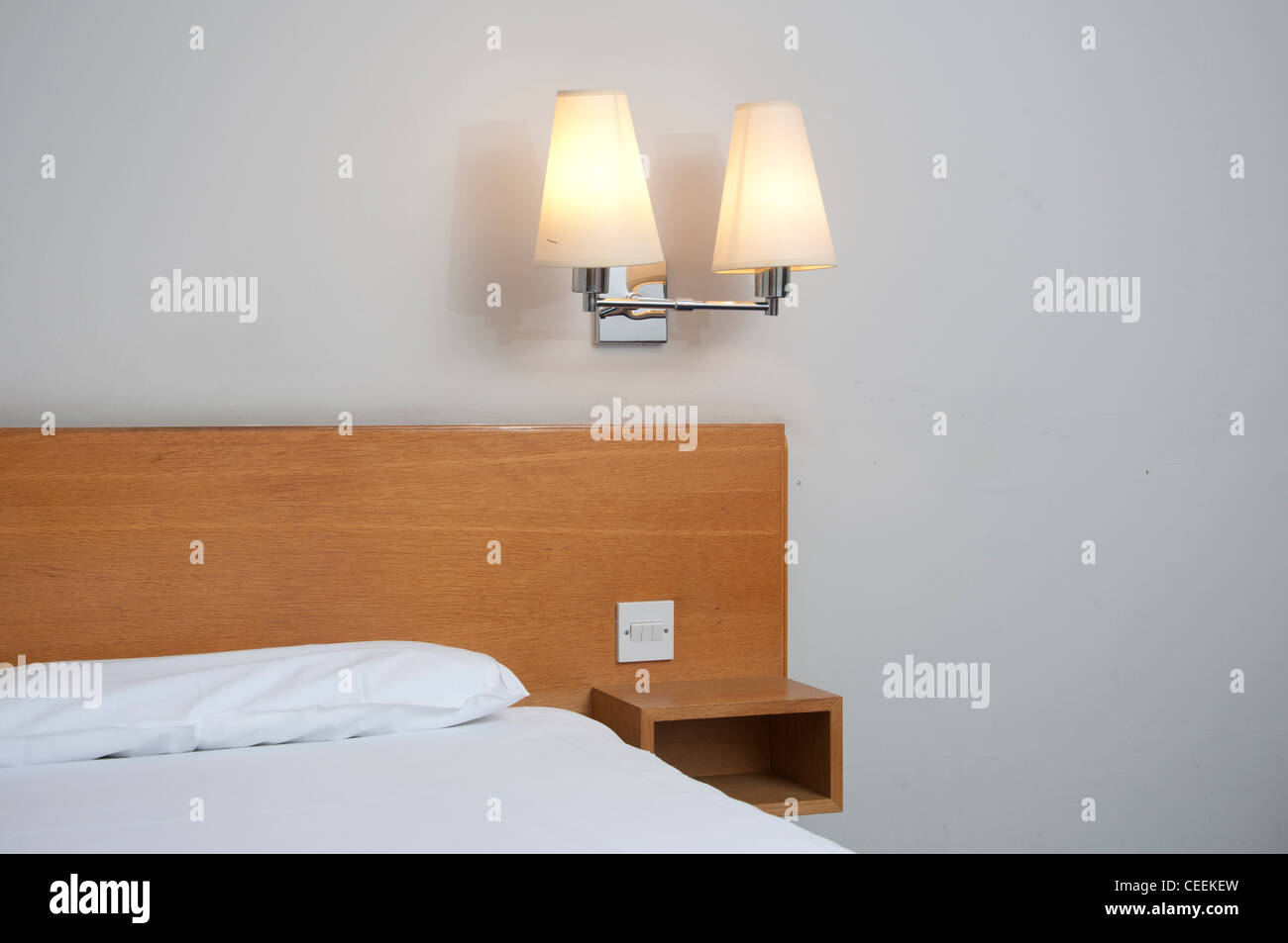 Travelodge budget hotel bedroom. Simple generic hotel room bed with ...