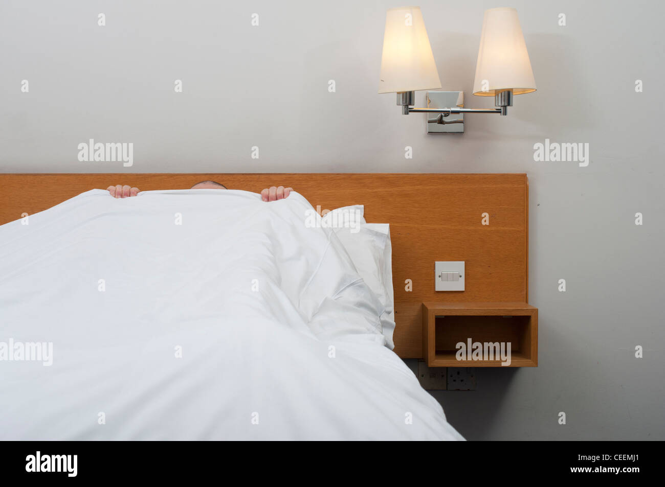 Hiding under covers scared hi-res stock photography and images - Alamy