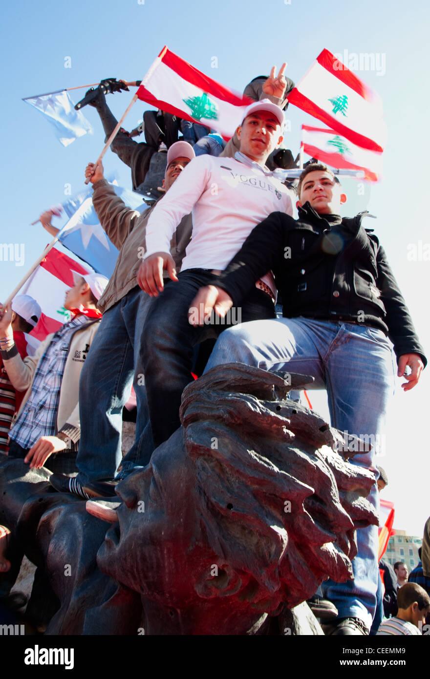 Political supporters with flags clamber over Martyrs Square monument in ...