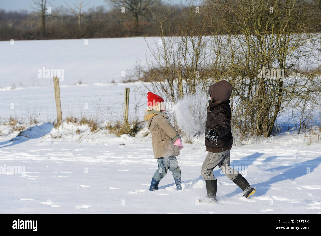 Children throwing snowballs hi-res stock photography and images - Alamy