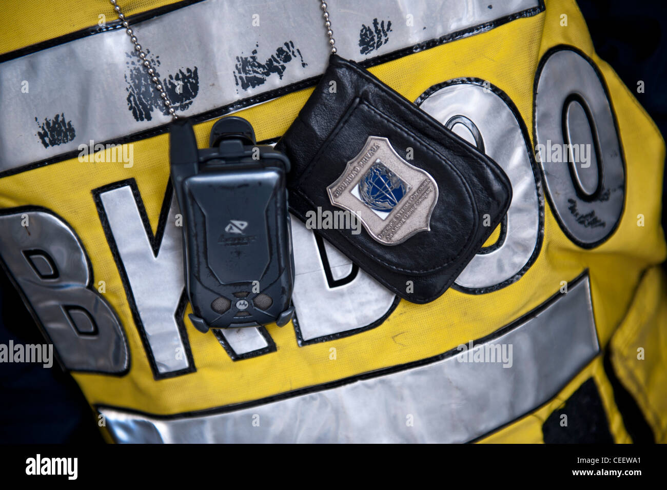 A motorbike rider wears a numbered bib to identify him. Security guards ...