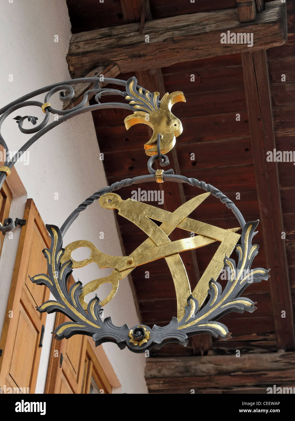 A traditional tradesman's sign hanging outside a clothes shop in ...