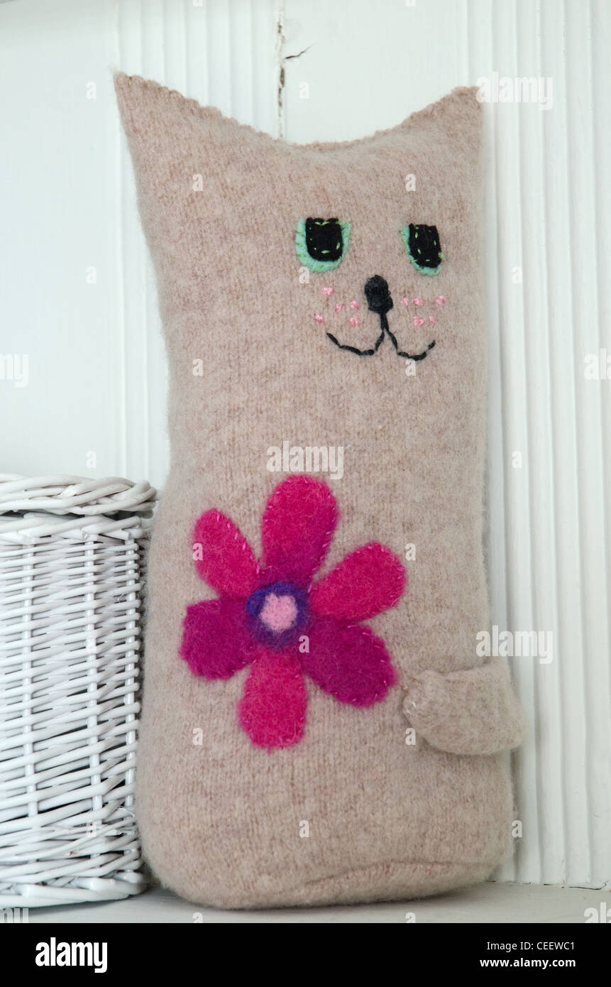 Upcycled handmade wool cat made from reclaimed fabric sat on a shelf ...