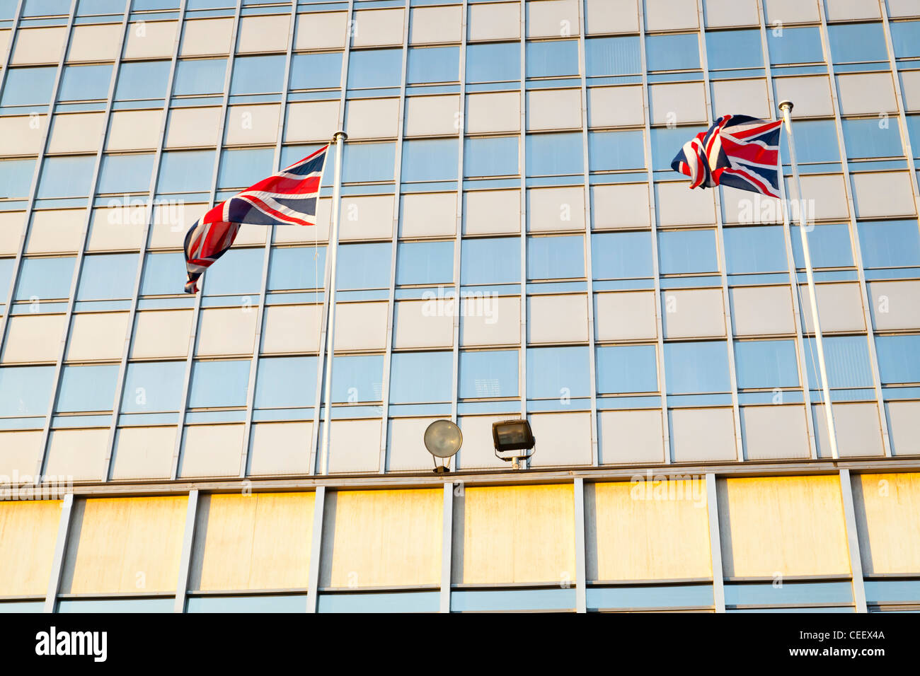 Union Jack flags. Two Union Jacks flying outside an office building in ...