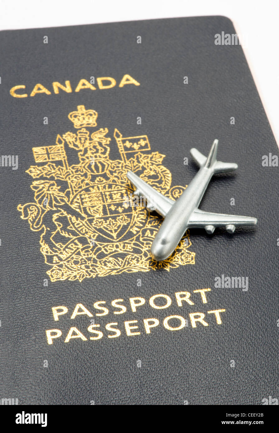 Passport with small plane model Stock Photo - Alamy
