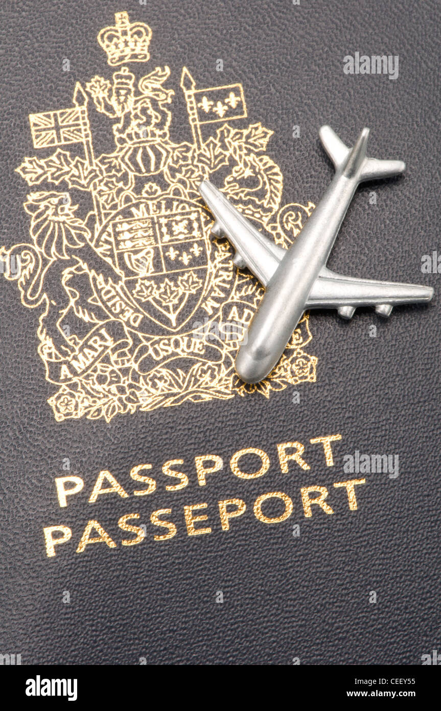 Passport with small plane model Stock Photo - Alamy