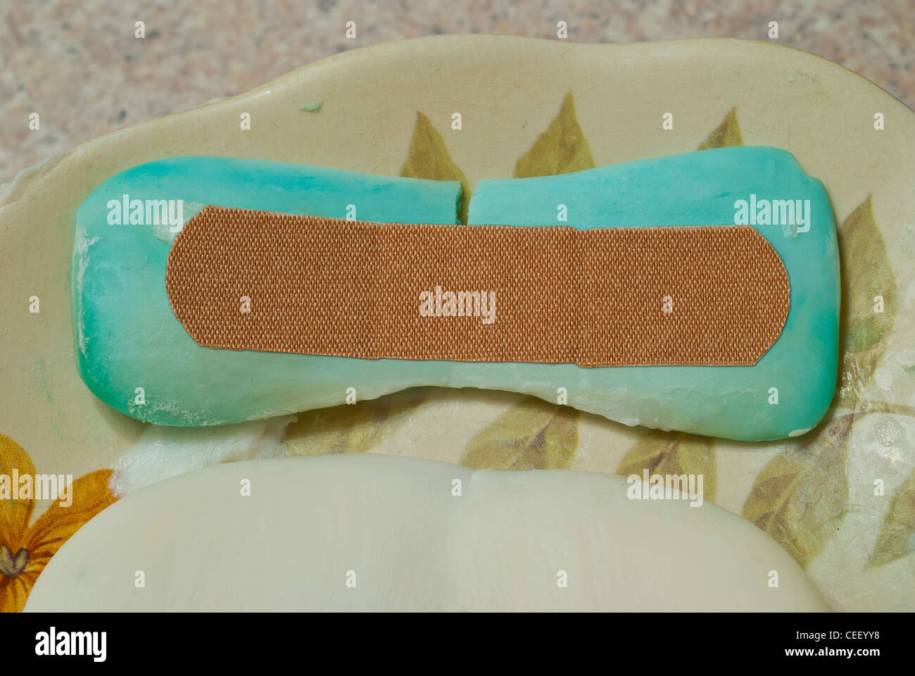 Bandage on worn out bar of soap. A band-aid fix. Some things just can't ...