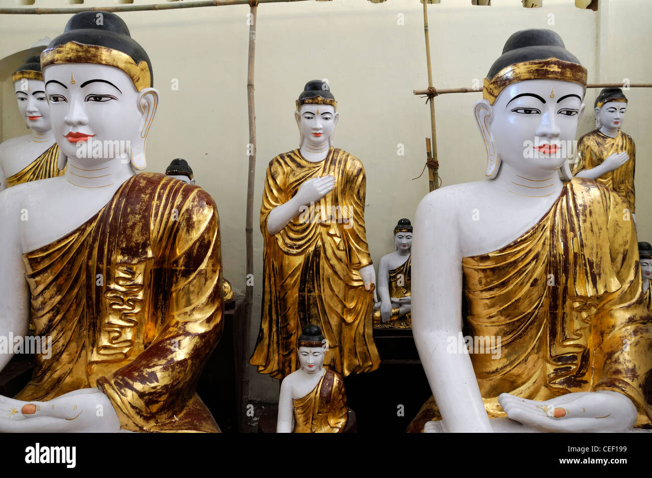 statue statues buddha buddhist gold orange yellow robe robes robed ...