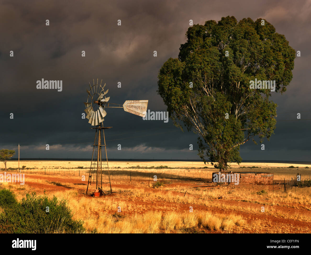 Storm over borehole pump, Namibia Stock Photo - Alamy