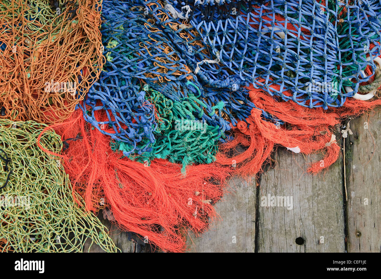 Tangled fishing nets on the old wooden pier Stock Photo - Alamy