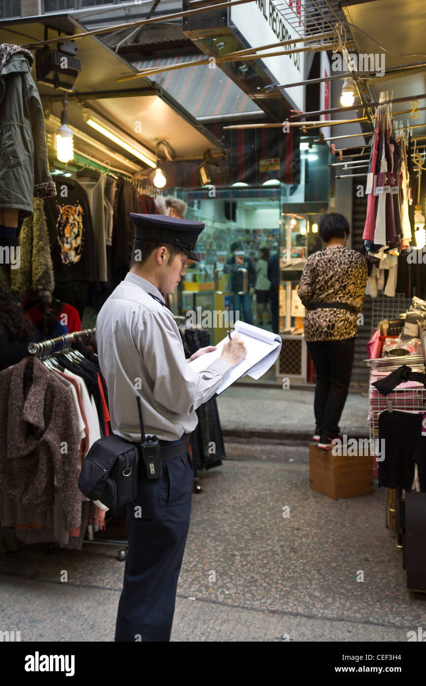 dh CENTRAL HONG KONG Chinese market inspector checking Hawker licences ...