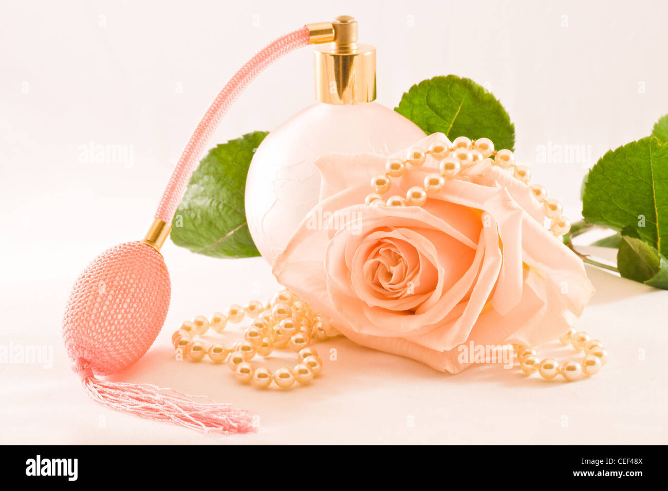 Pink glass scent-bottle with rose and pearls Stock Photo - Alamy