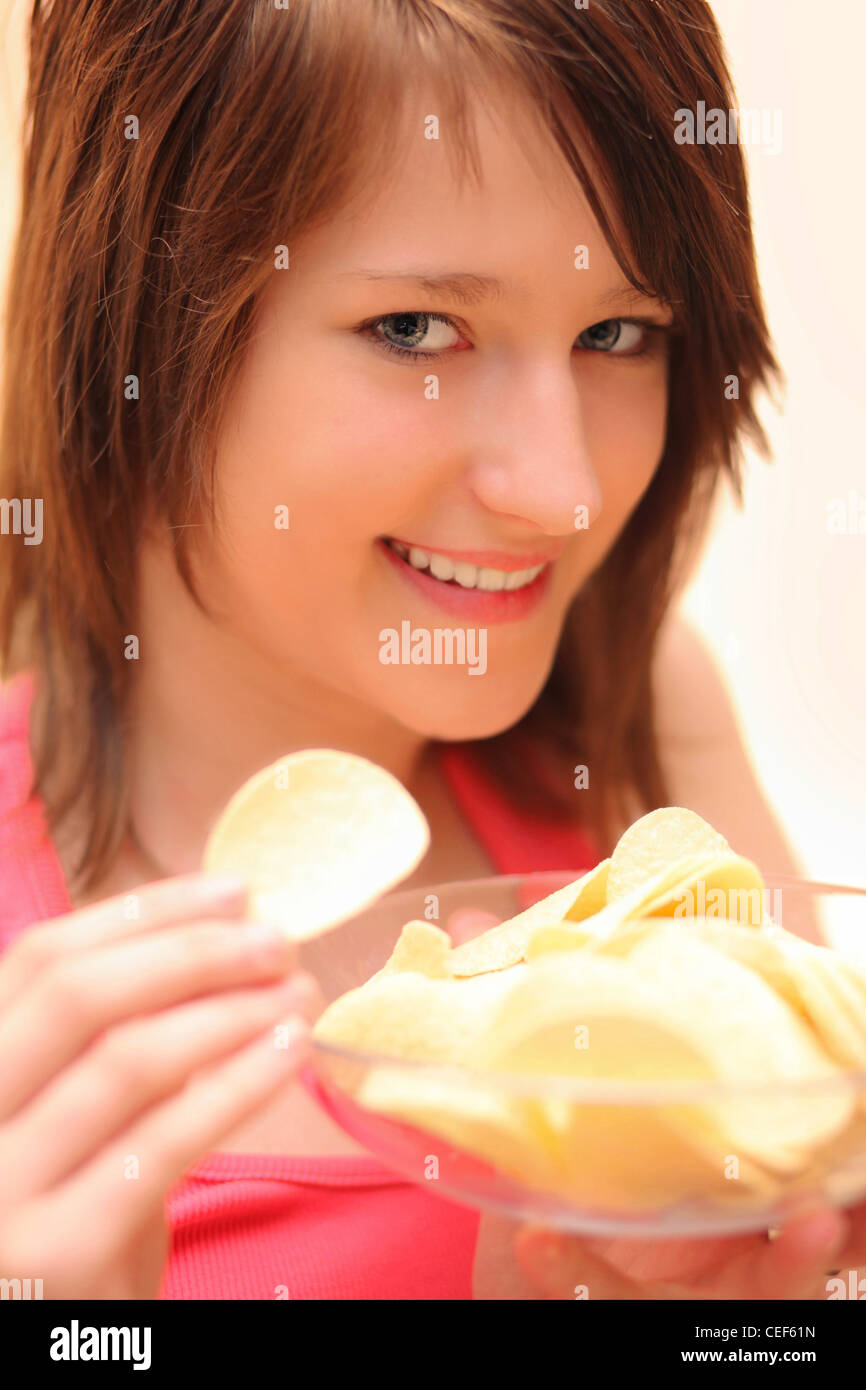 Teenage girl is eating chips Stock Photo - Alamy