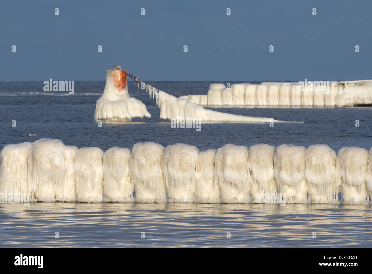 Icy sea walls on the Polish Baltic Coast. In the background you can see ...